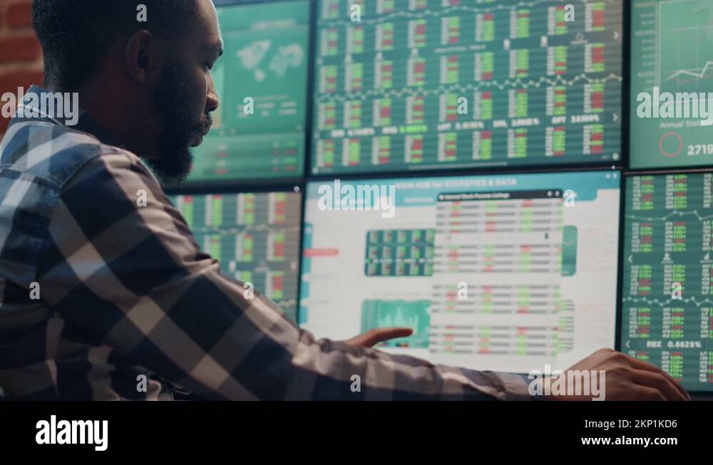 Financial analyst monitoring forex exchange numbers in office Stock ...