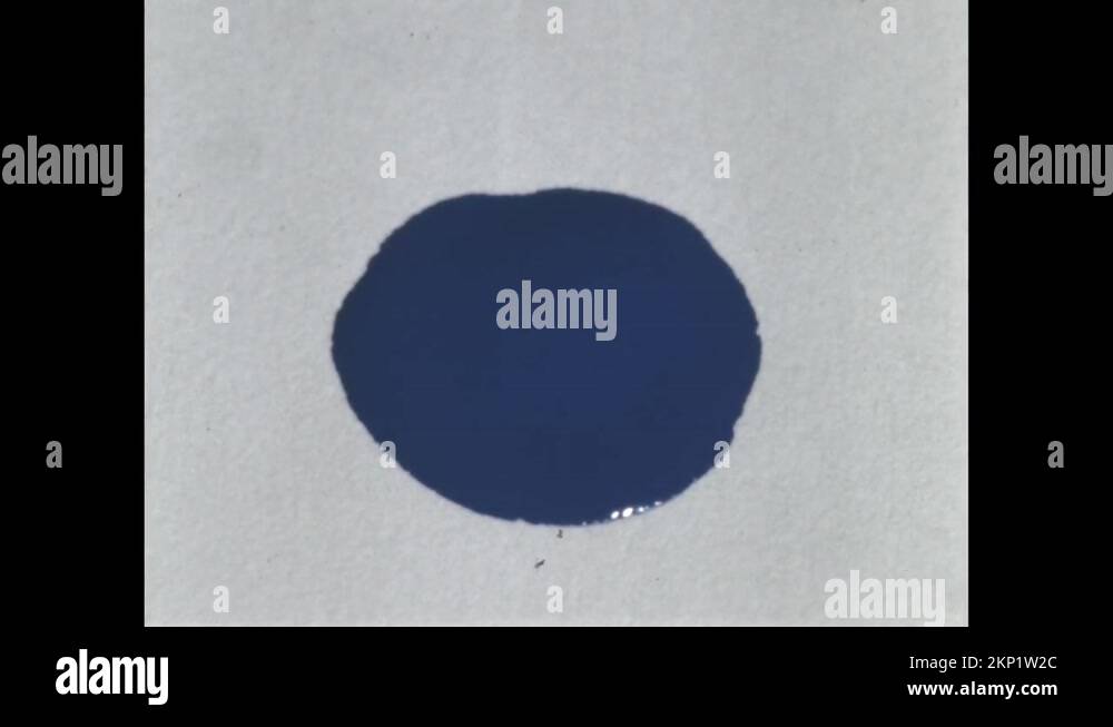 1960s: Dot of blue paint. Dot of black paint. Brush dips into the black ...