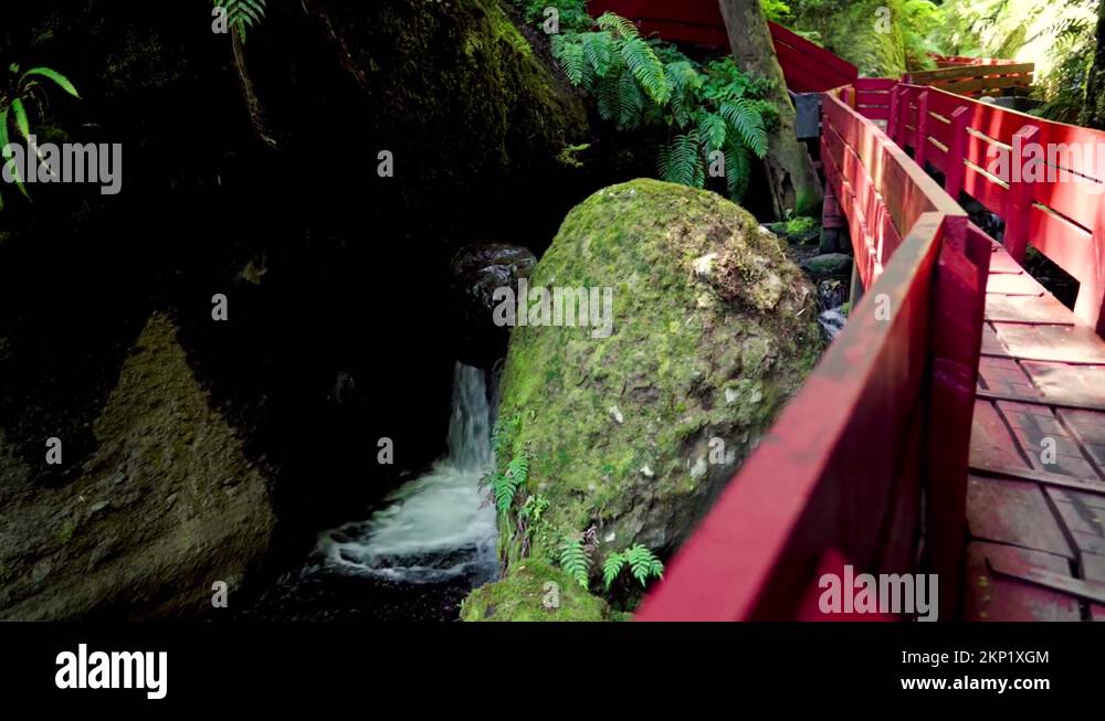 Dolly in of natural pools and red wooden deck in Termas Geometricas hot ...