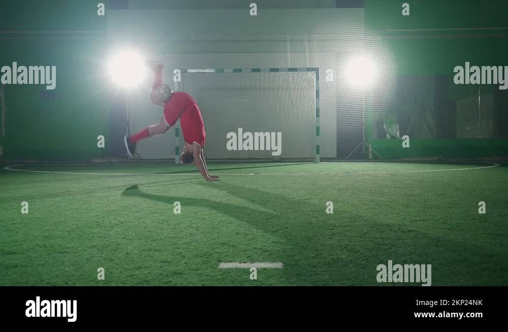 Professional football player performs a tricks with a soccer ball ...