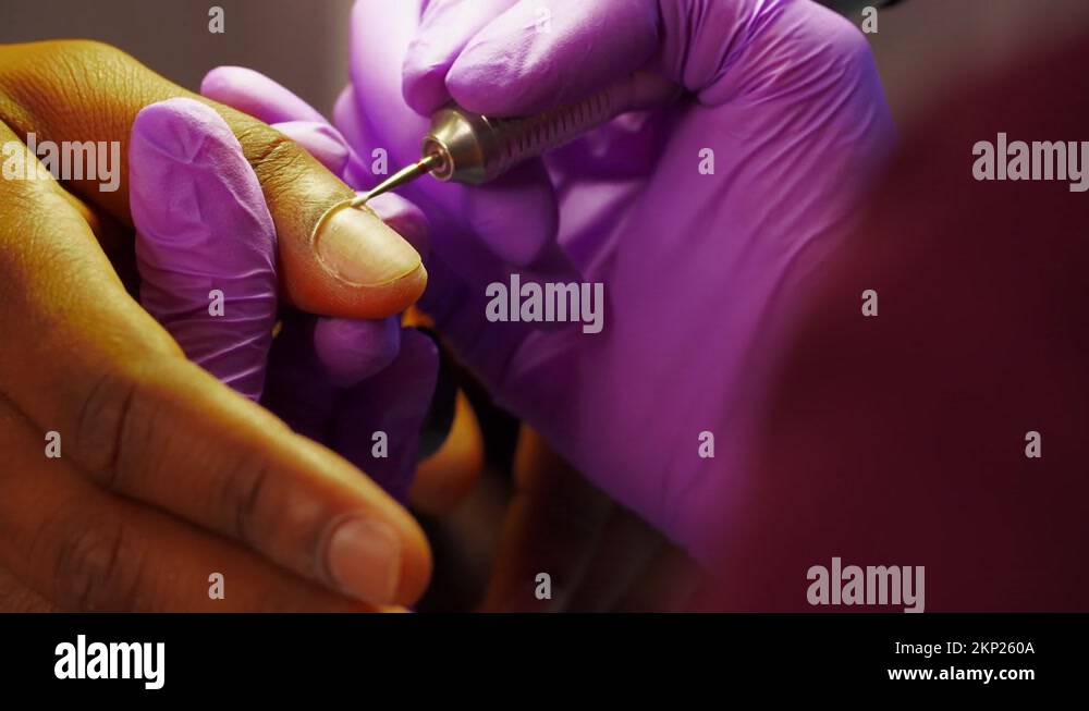 Macro footage of apparatus manicure made by electric frame to black man ...