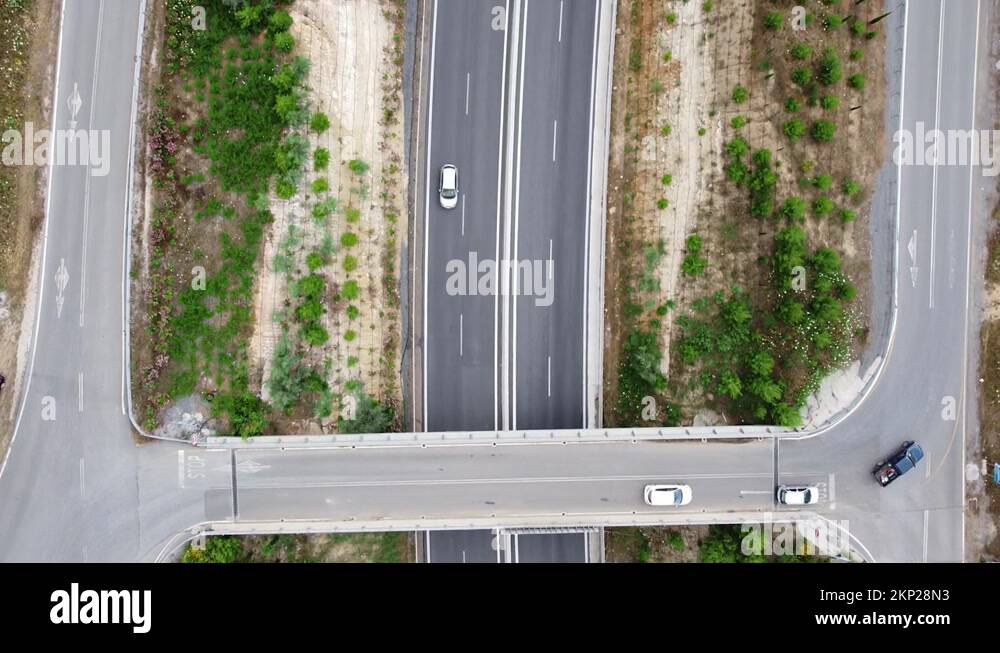 Infrastructure scene. Aerial view of highway road and overpass and cars ...
