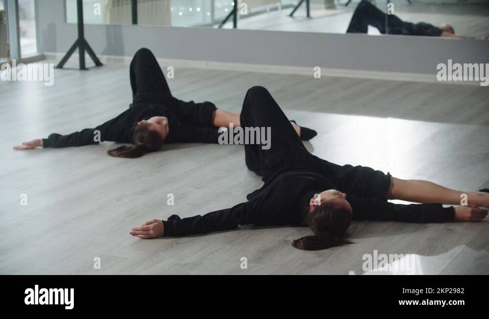Little girl twins synchronously stretching in the studio Stock Video ...