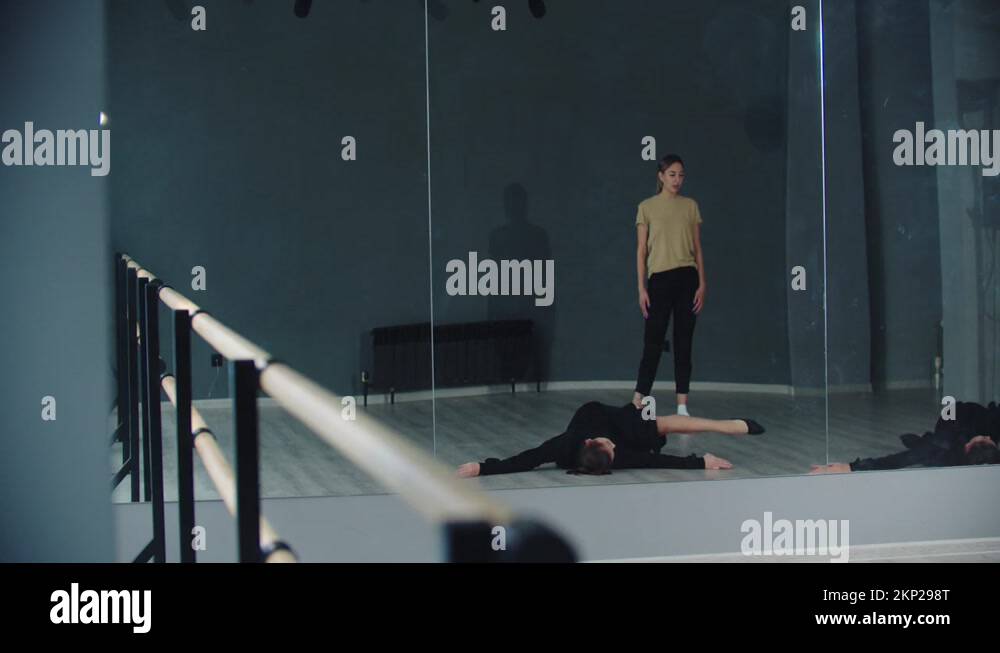 Little girl twins synchronously stretching in the studio and their ...