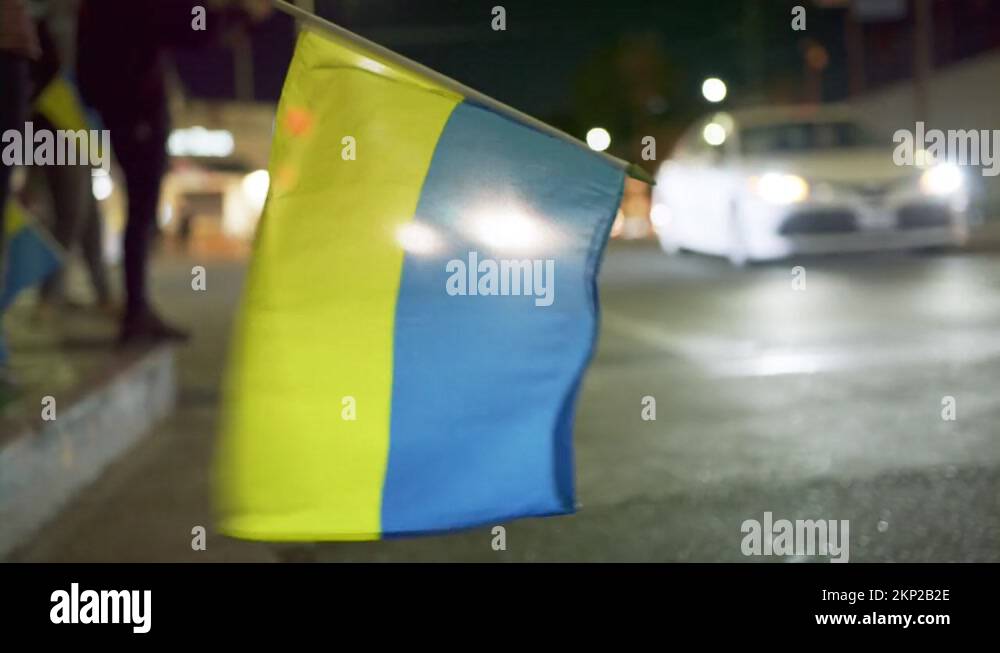 Crowd waving yellow and blue Ukrainian flags and STOP WAR, STOP PUTIN ...