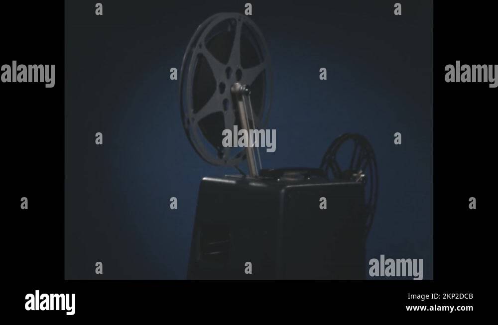 1960s Film running through a movie projector. A backhoe digs a hole in ...