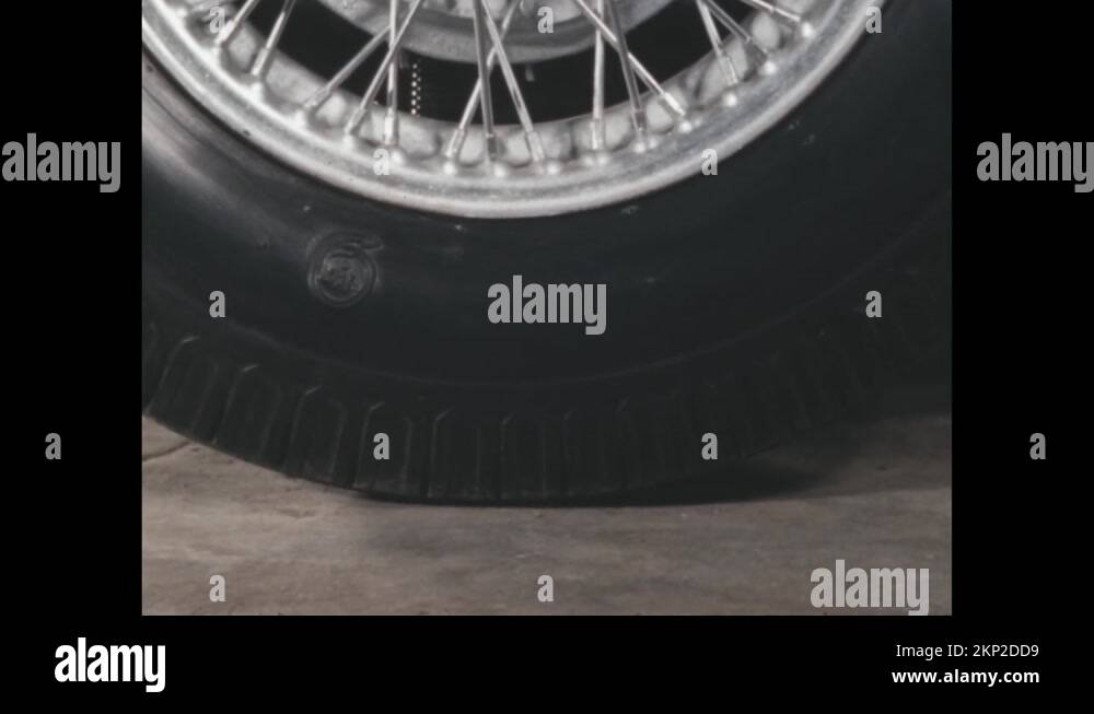 1960s: Slate. Tire being slowly lifted off of the floor. Slate Stock ...