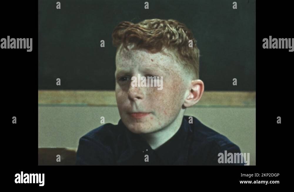 1950s: Man holds shooting slate. Boy waves. Boy speaks. Classroom Stock ...