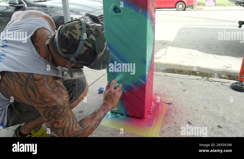 Graffiti Artist With Sprays Paints Parking Meter Column in Wynwood ...