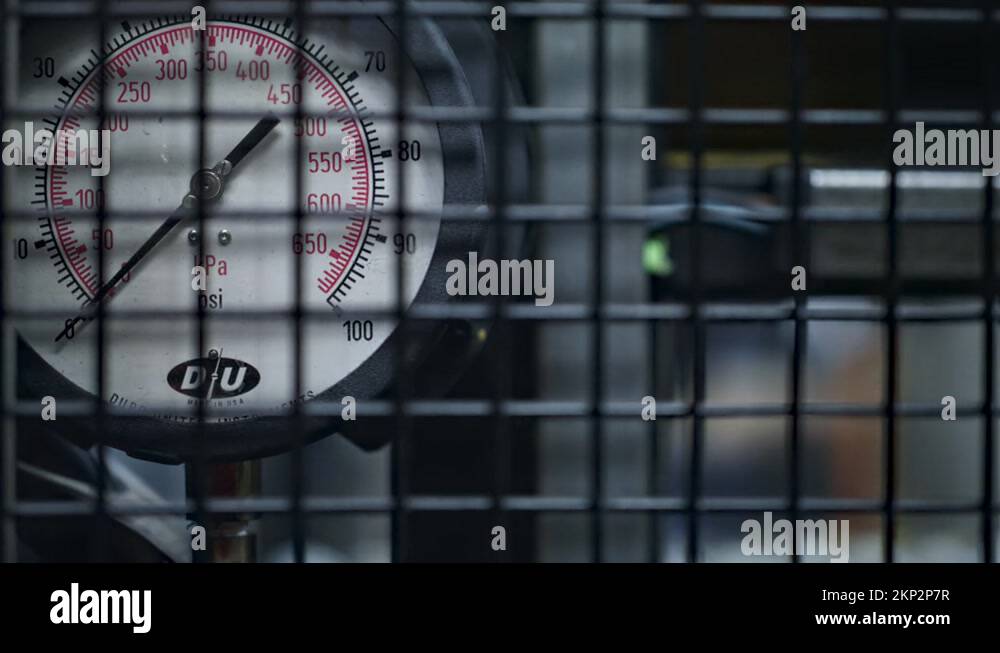 Factory machine indicator micrometer displaying pressure measurement at ...