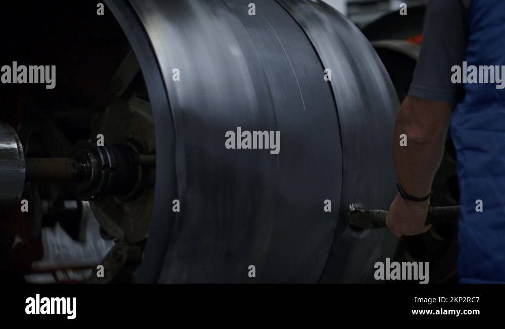 Tyre production factory employee controlling manufacturing process ...