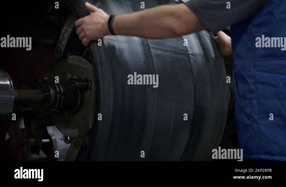 Tyre manufacturing workshop employee checking production automat ...