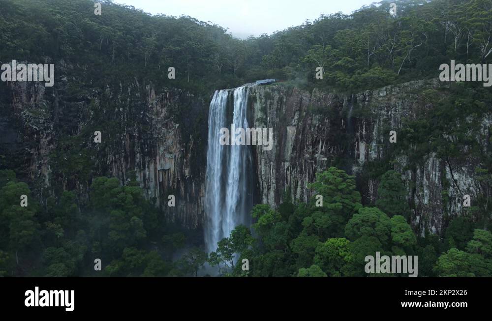 Panoramic view of a majestic waterfall spilling down a tropical ...