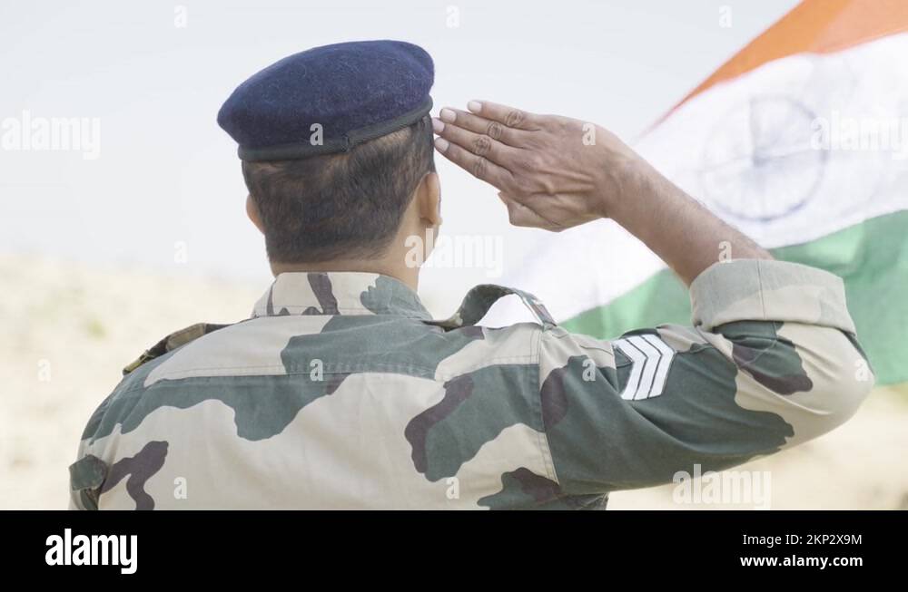 back view shot of Proud Indian army soldier saluting by looking indian ...
