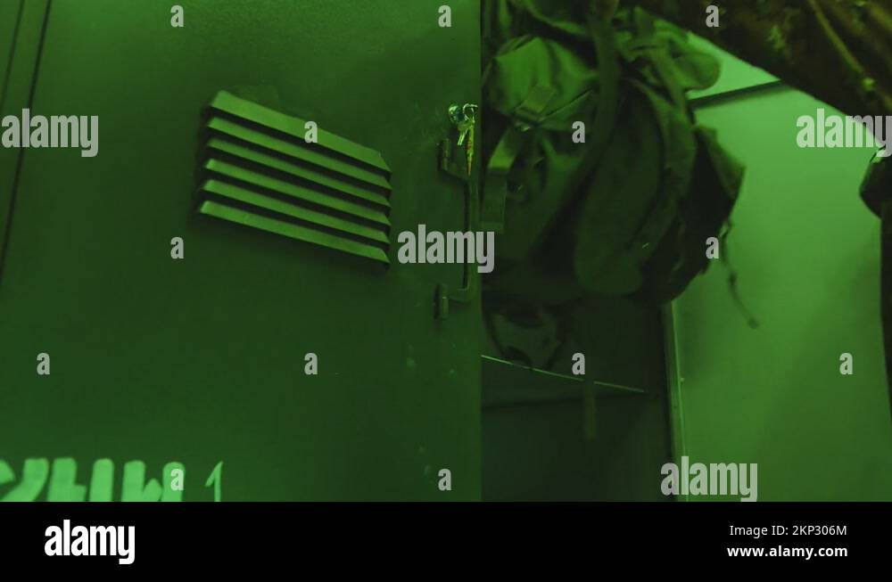 Soldiers Putting Bag Inside Safe Of Military Locker Room Or Storage