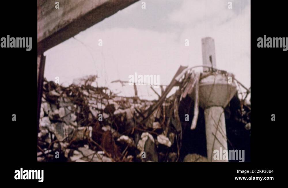 1940s: Concrete pillars, rubble and rebar after explosion. One wall ...