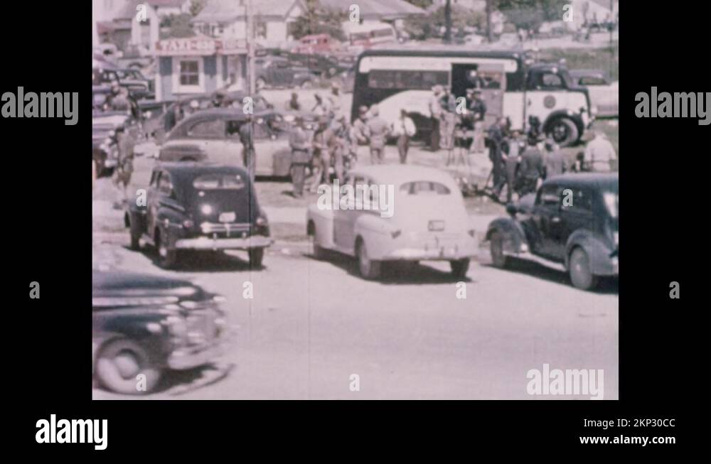 1940s: Emergency crews and response teams in street. Billowing smoke on ... 1940s: Emergency crews and response teams in street. Billowing smoke on ...