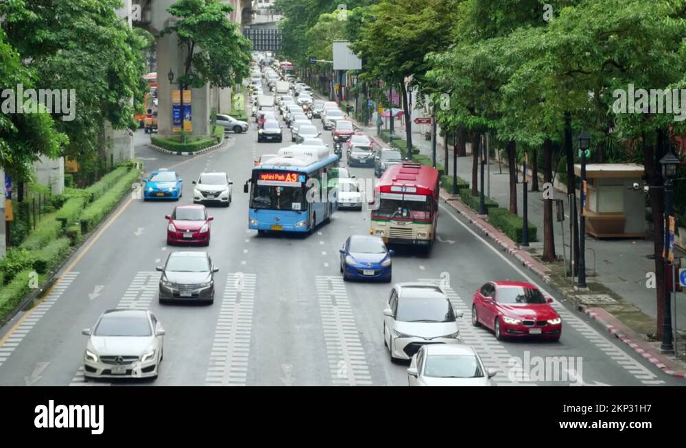Traffic through busy intersections at rush hour in Bangkok which is ...