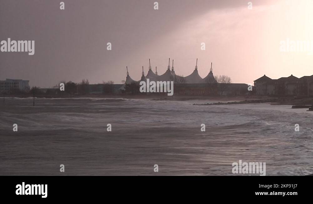 Stormy sea and sky with Butlins Holiday Camp in the background. Bristol ...