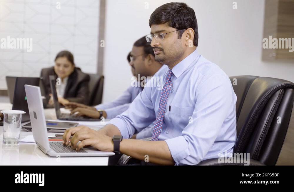 Young smiling corporate employee working with showing thumbs up by ...