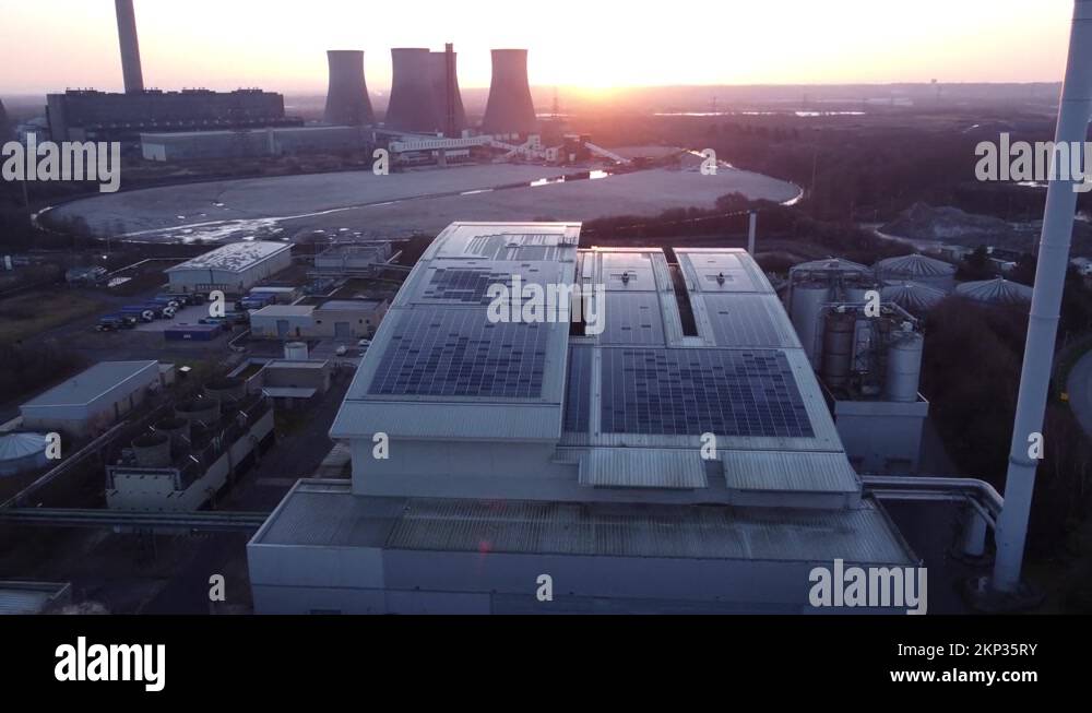 Glowing sunrise over solar panels industrial installation factory ...