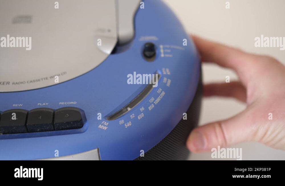 man tuning fm frequency on 2000s style radio with hand, closeup ...