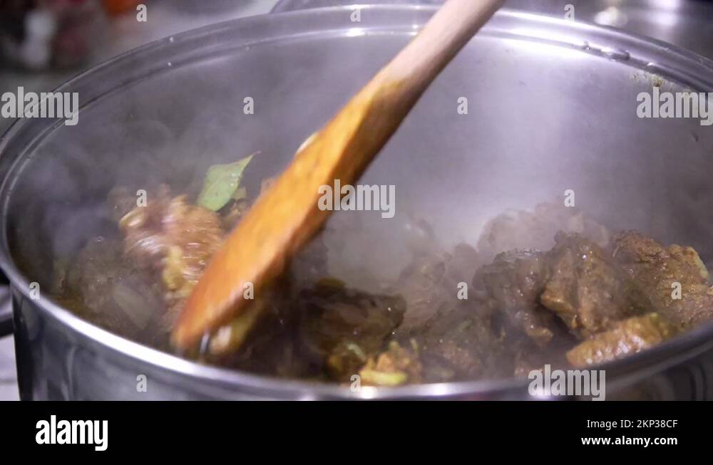 Cooking authentic Jamaican curry goat. Stirring the pot Stock Video ...