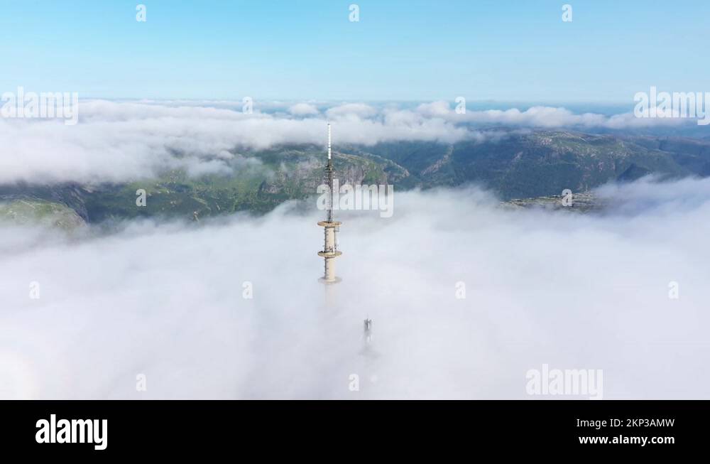 circling radio tower above clouds with mountains revealed beneath Stock Video Footage - Alamy