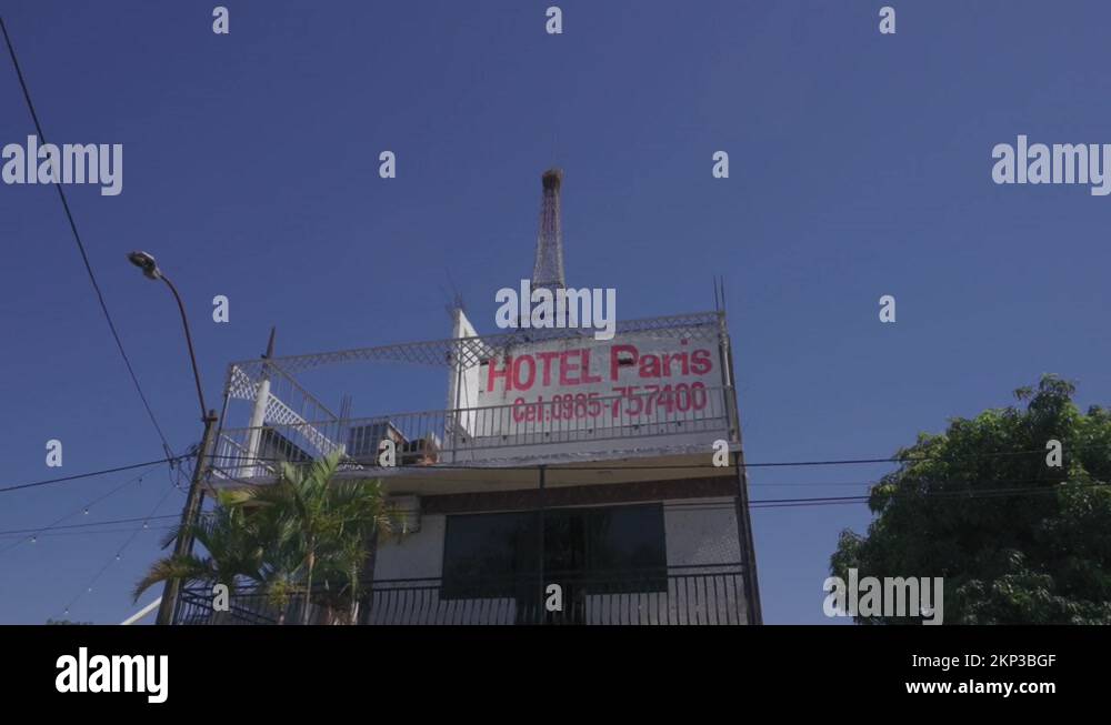 Facade of rustic Hotel Paris with Eiffel Tower replica. Gimbal, low ...