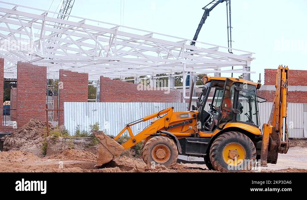 Yellow tractor on a construction site. Professional construction ...