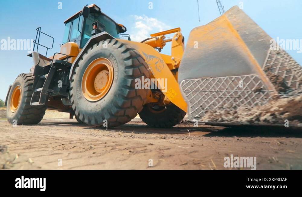 Yellow tractor on a construction site. Professional construction ...