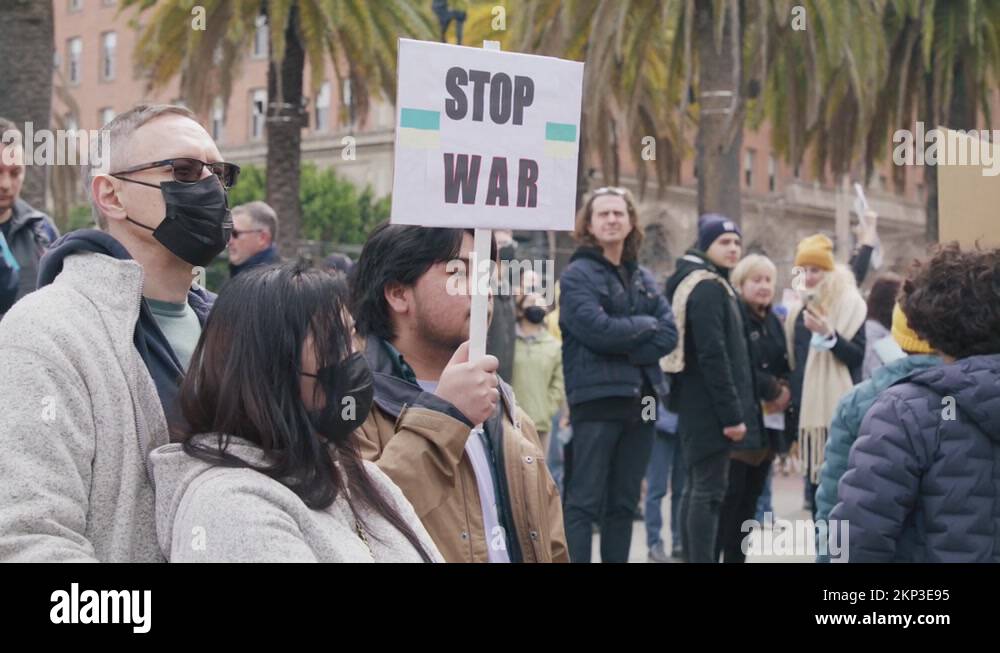 Crowd people with yellow blue Ukrainian flags and STOP WAR signs, San ...