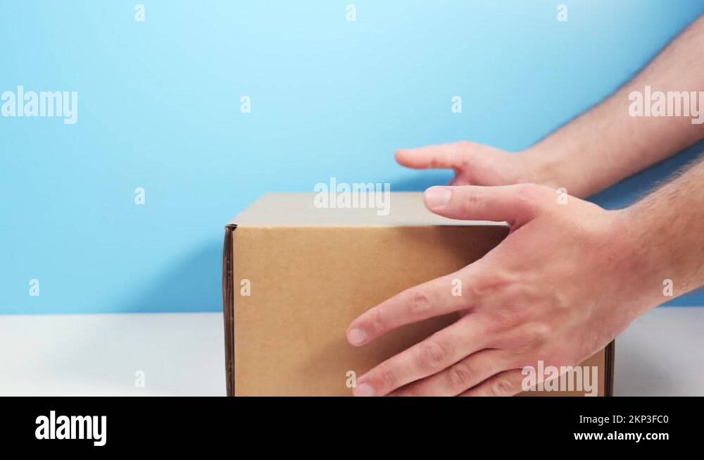 Close up hands man receive a cardboard box from a woman's delivery ...