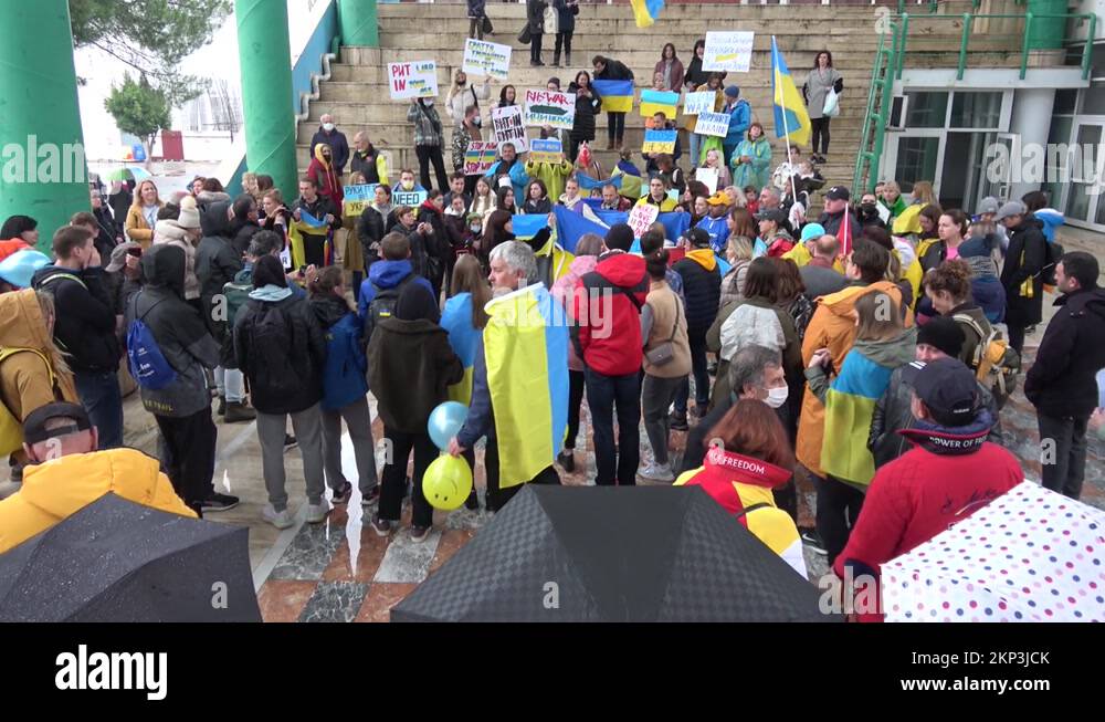 Demonstration under yellow blue flags againsts Putins war in rainy day ...
