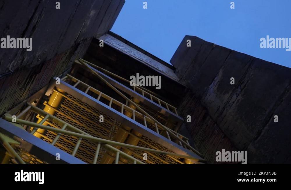 Drops of rainwater flow down from the roof of industrial building ...