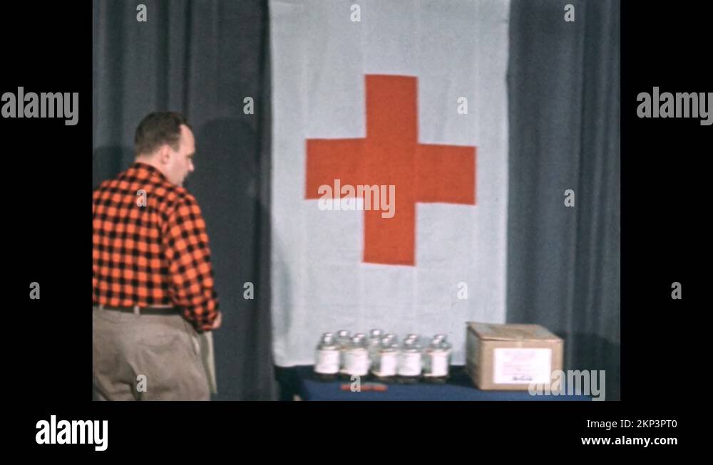 1950s: Television studio. Camera films woman giving demonstration. Man ...