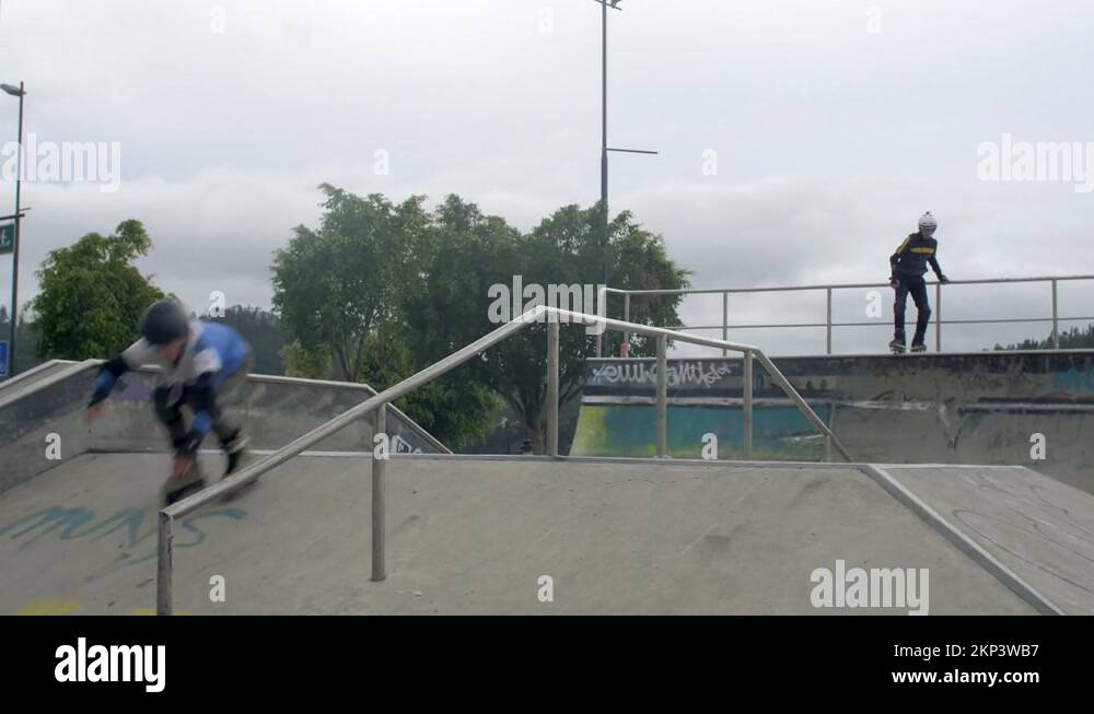 two young boys jumping at skatepark Stock Video Footage - Alamy