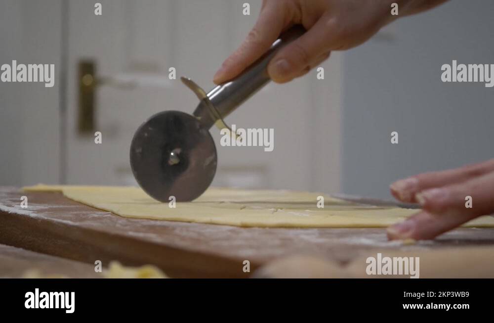 Baker Cutting Flattened Dough With Pizza Cutter. Making Faworki (Polish ...