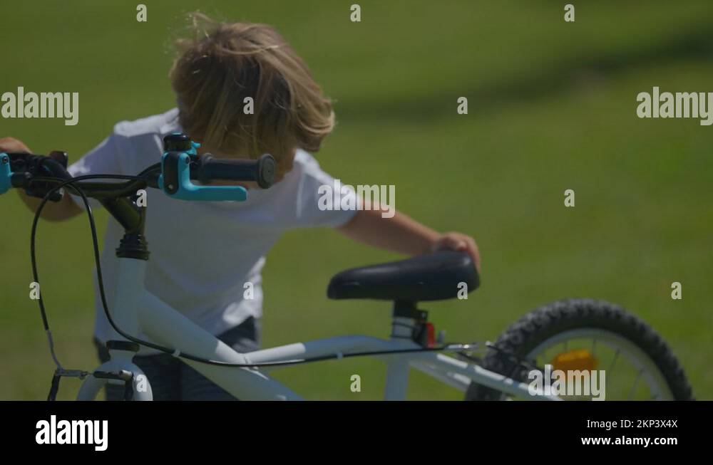 Boy pushing bicycle Stock Videos & Footage - HD and 4K Video Clips - Alamy