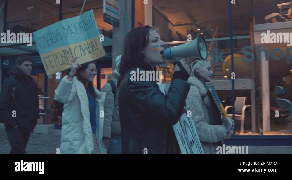 Woman with megaphone marching against Russia Ukraine war Stock Video ...