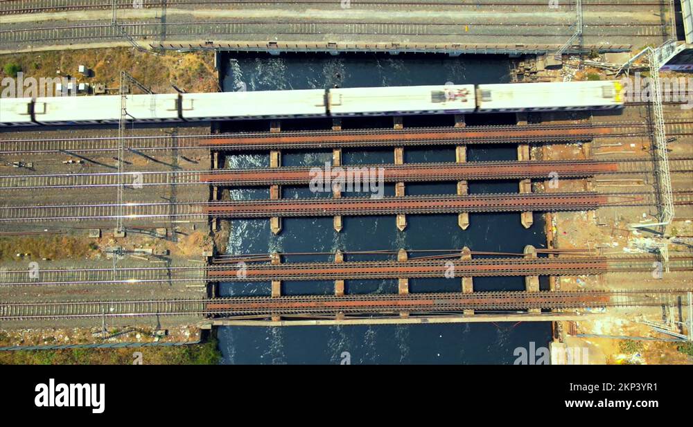 local train moving over mith river near bandra station drone shot ...