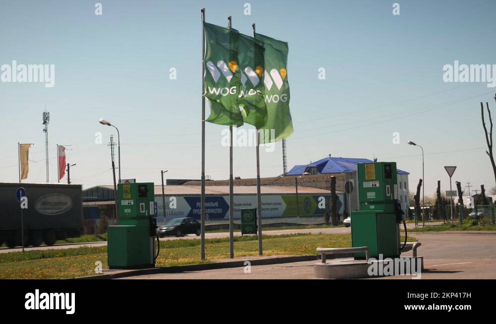 Petrol gas station for refueling car tanks with green flags waving in ...
