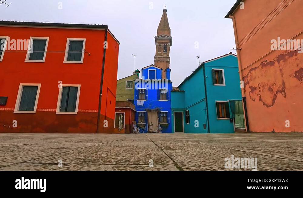 Low angle ground surface fpv pov toward colorful houses and leaning ...