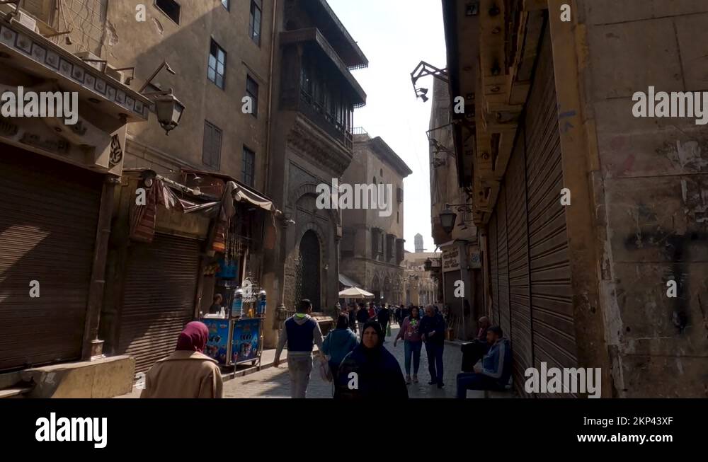 Egyptian people walking in pedestrian street of old Cairo historic town ...