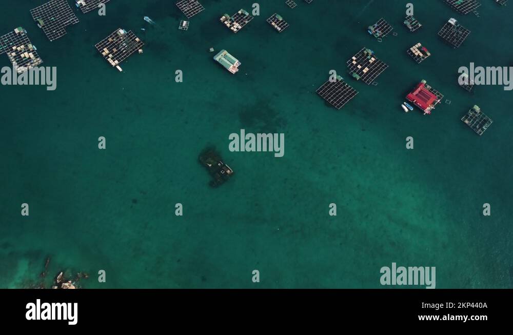 Floating fish farms on ocean surface in Southeast Asia. Aerial top down ...