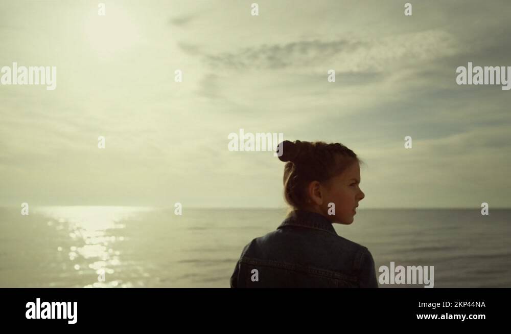 Sad kid looking sea beach outdoors. Cute girl child missing family on ...