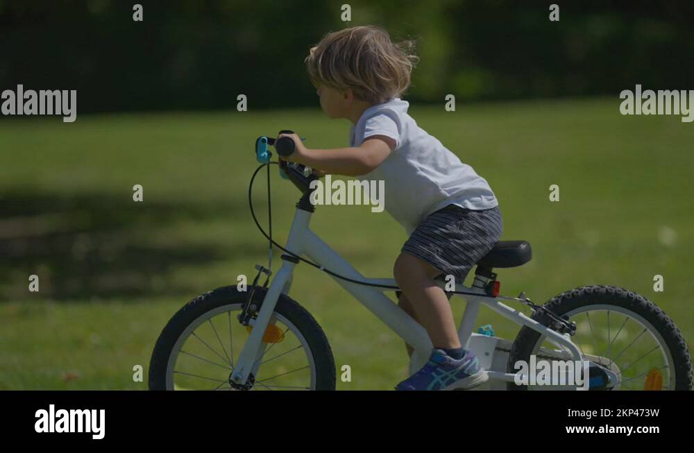 Boy pushing bike Stock Videos & Footage - HD and 4K Video Clips - Alamy