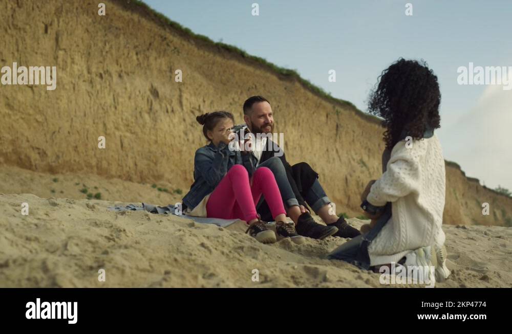 Calm family spend time together on sea beach. Happy people taking ...