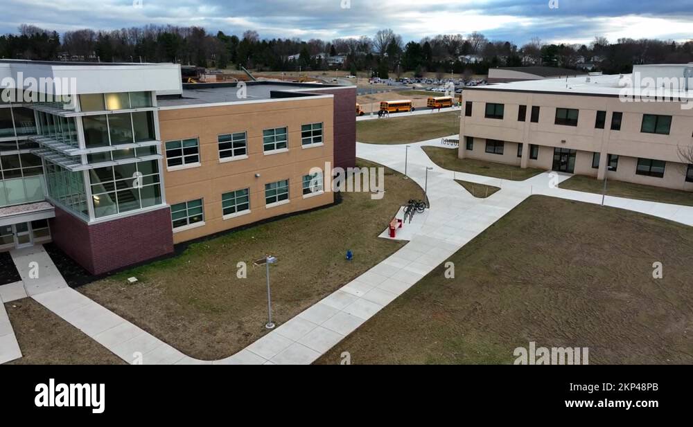 Modern school buildings at public education facility. School bus line ...