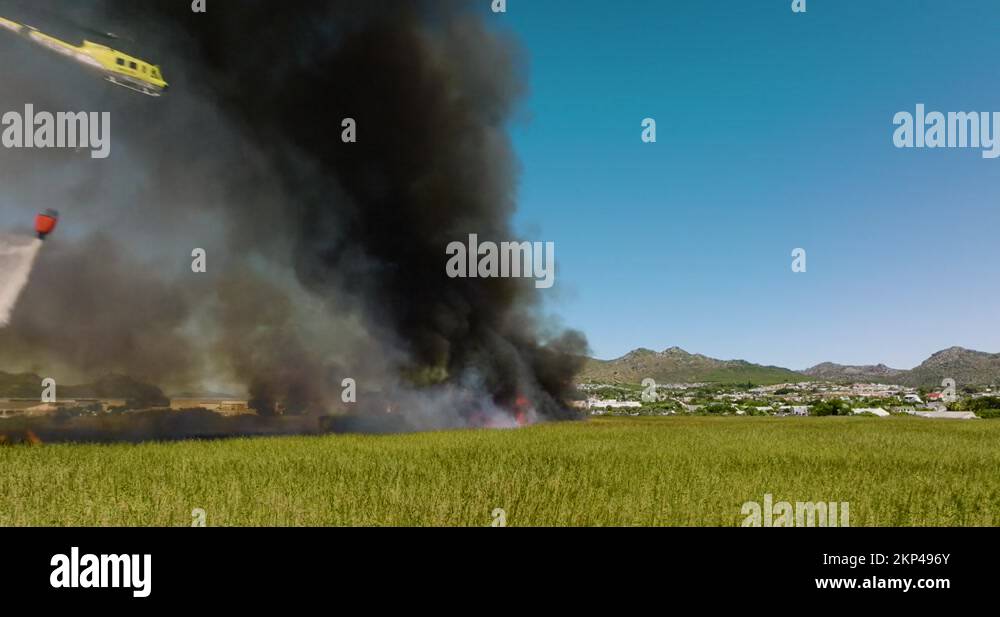 Climate emergency.Climate change.Global warming.Helicopter dousing a ...